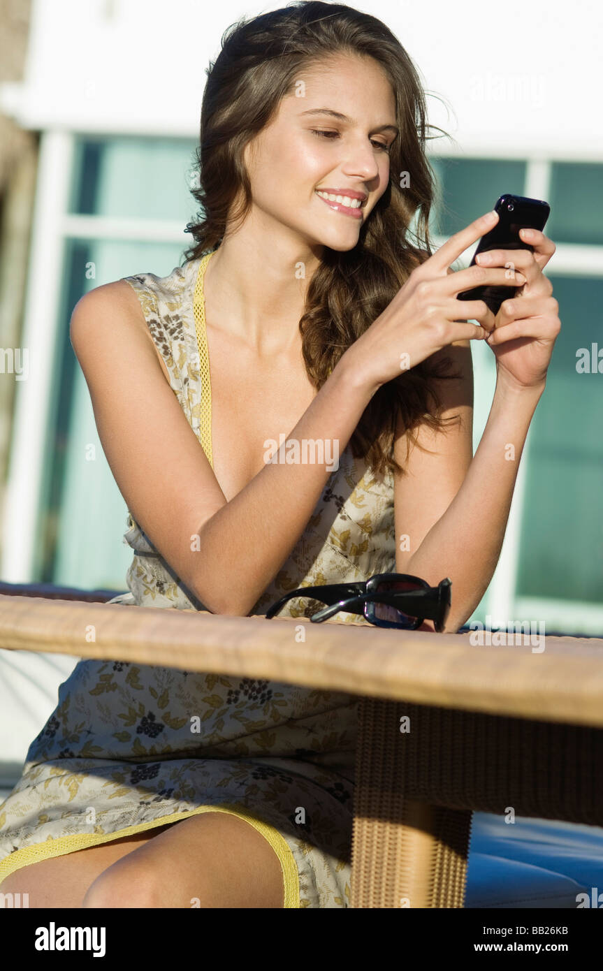 Woman text messaging and smiling Stock Photo - Alamy
