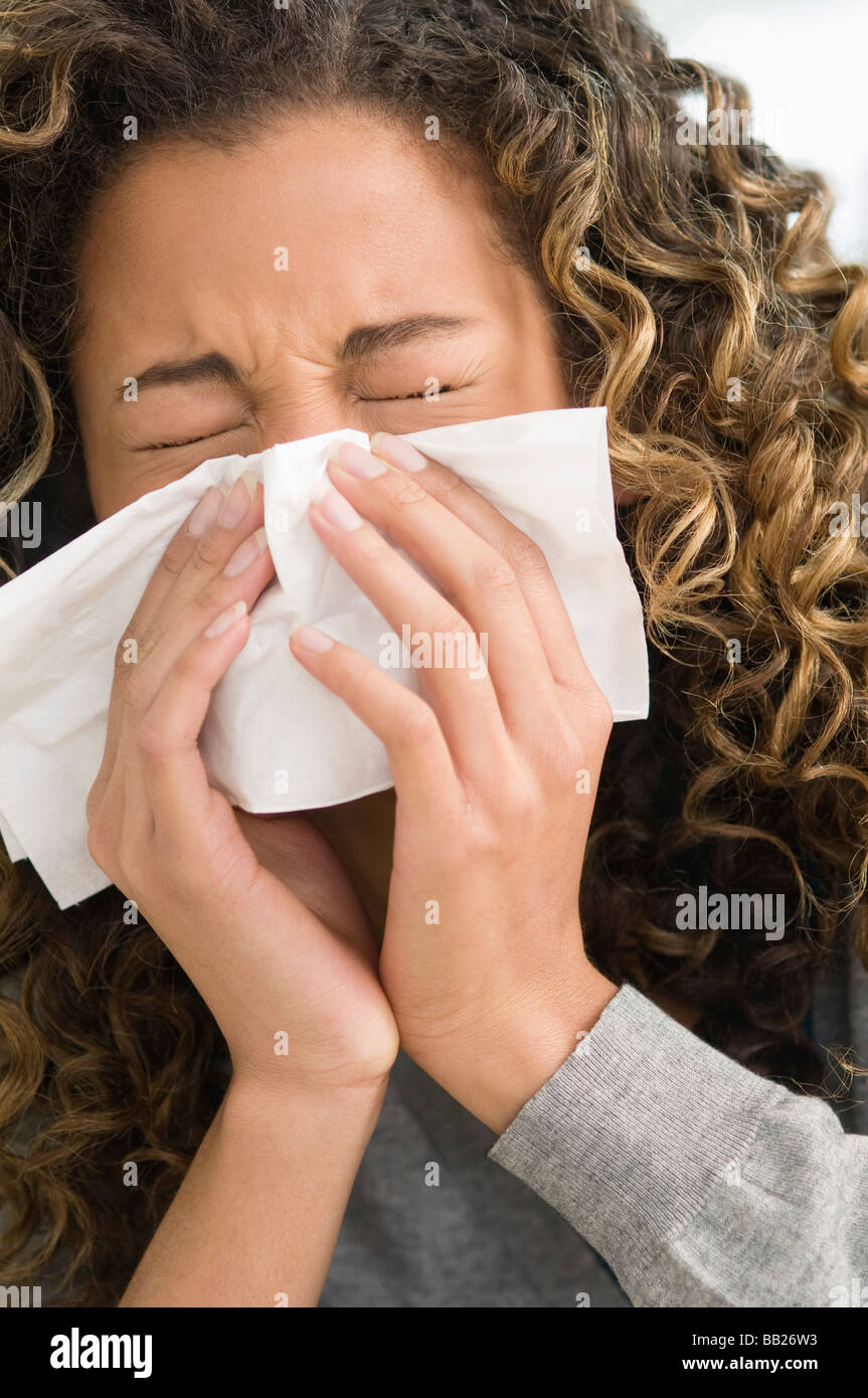 Close-up of a girl blowing nose Stock Photo - Alamy