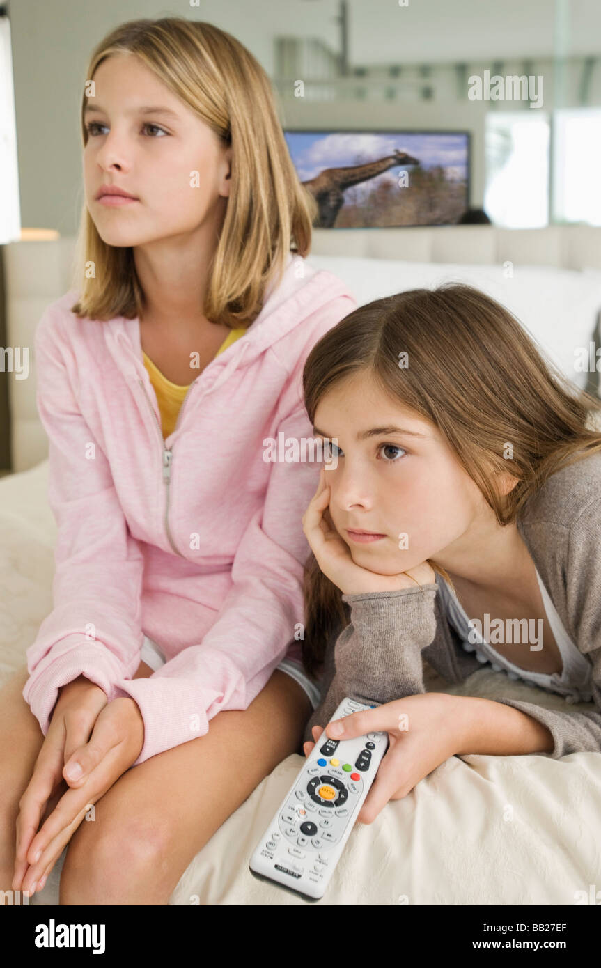Two girls watching television Stock Photo - Alamy