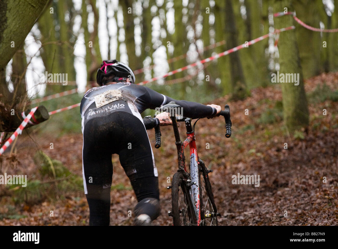 Cyclocross rider off his bike toils up hill Stock Photo - Alamy