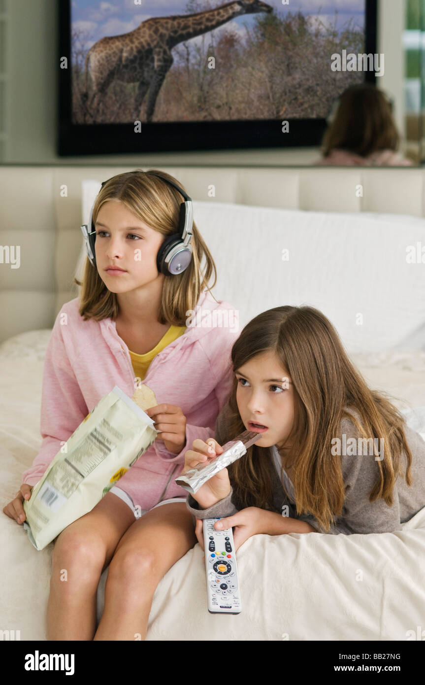 Two girls watching television Stock Photo - Alamy