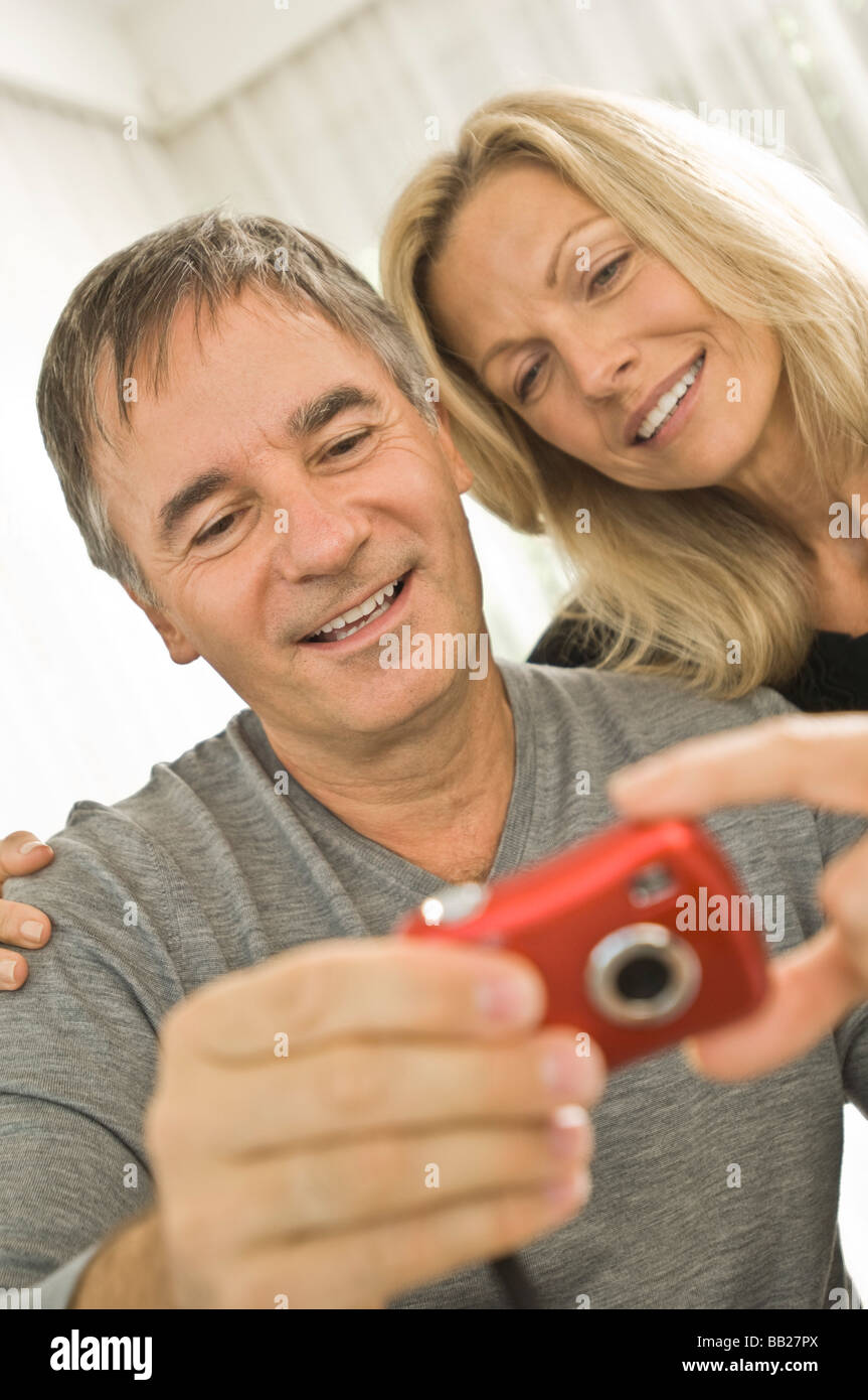 Couple looking at a digital camera Stock Photo - Alamy