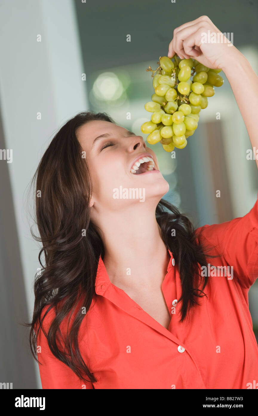 Woman eating grapes Stock Photo - Alamy