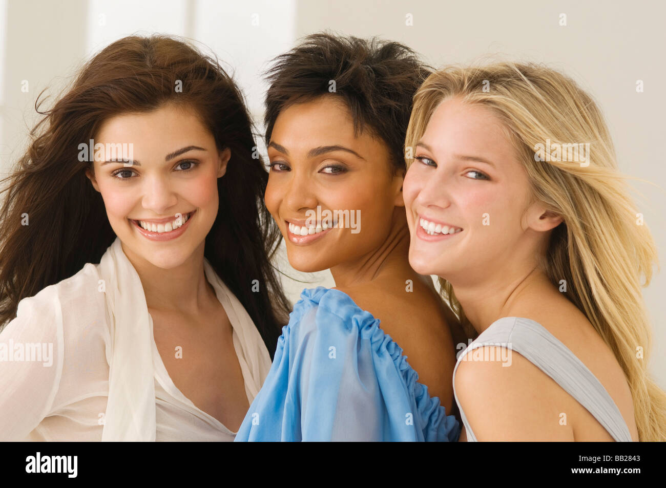 Portrait of three female friends smiling Stock Photo - Alamy