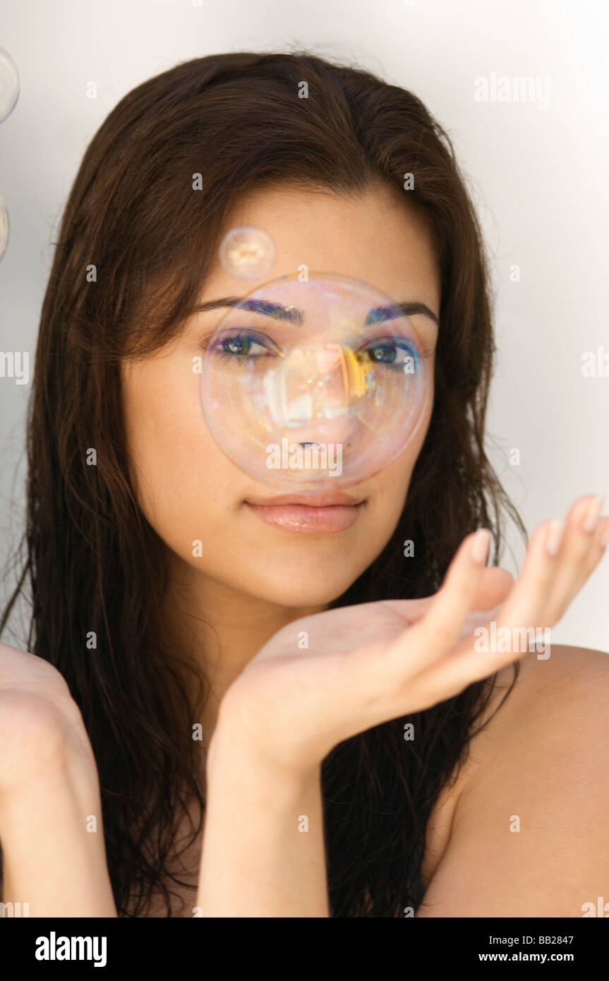 Soap bubble in front of a woman's face Stock Photo - Alamy