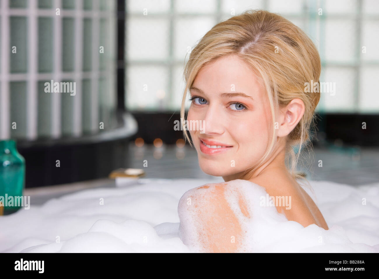Woman taking a bubble bath Stock Photo - Alamy