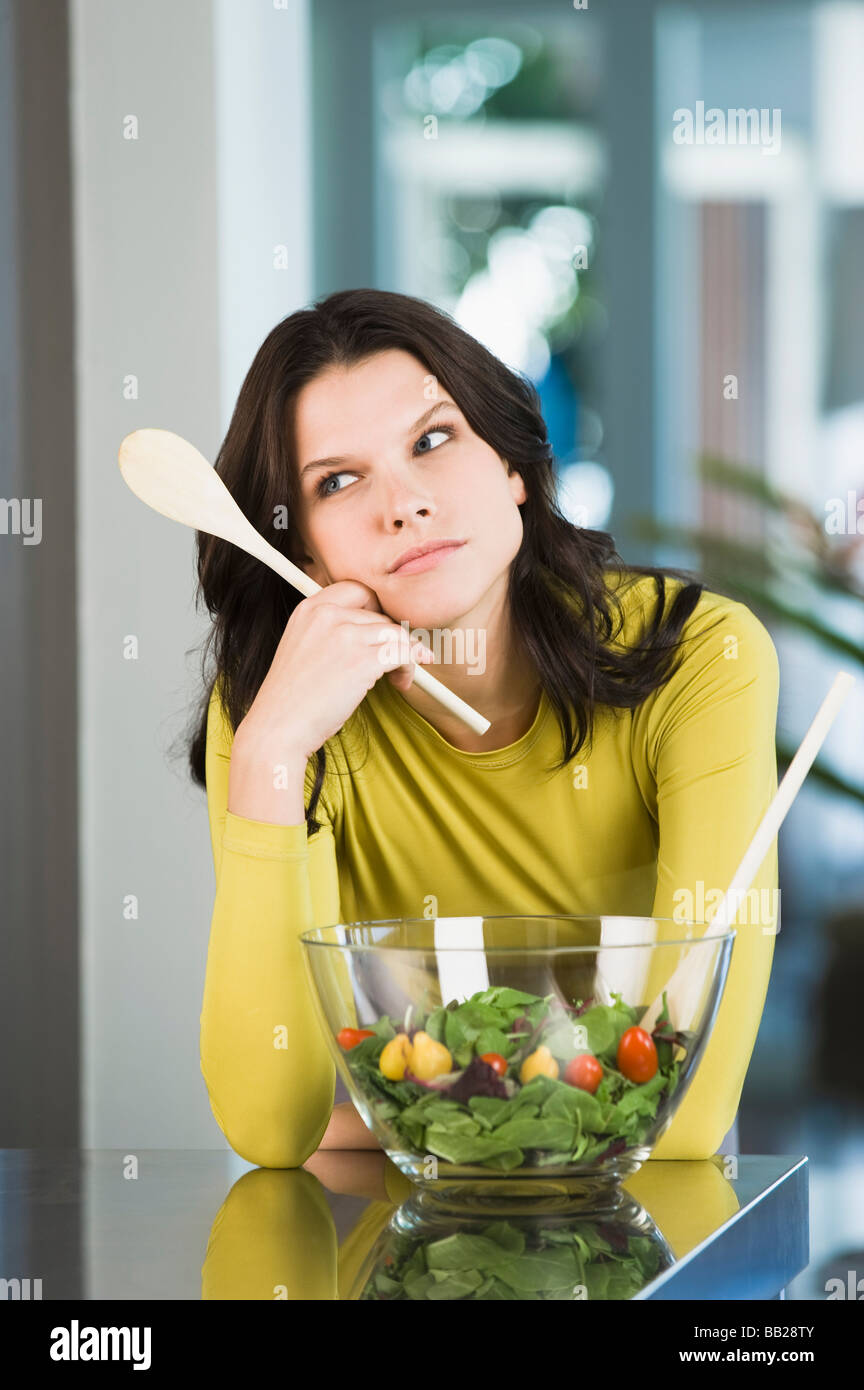 Woman thinking in the kitchen Stock Photo - Alamy