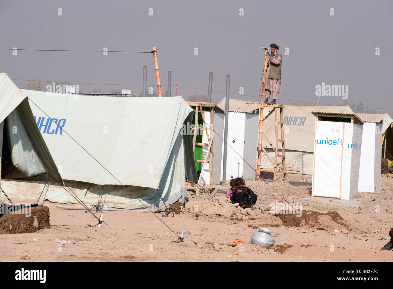 A displaced man working in a camp, Peshawar, NWFP Stock Photo - Alamy