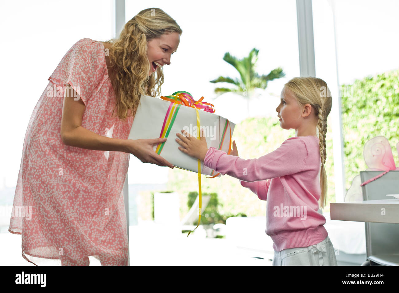 Girl giving present to her mother Stock Photo - Alamy