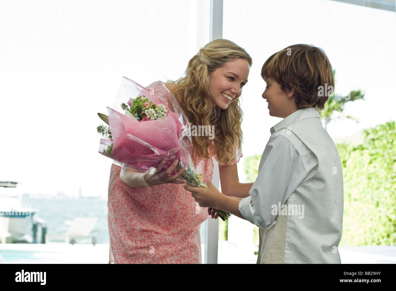 Boy giving a bouquet of flowers to her mother Stock Photo - Alamy