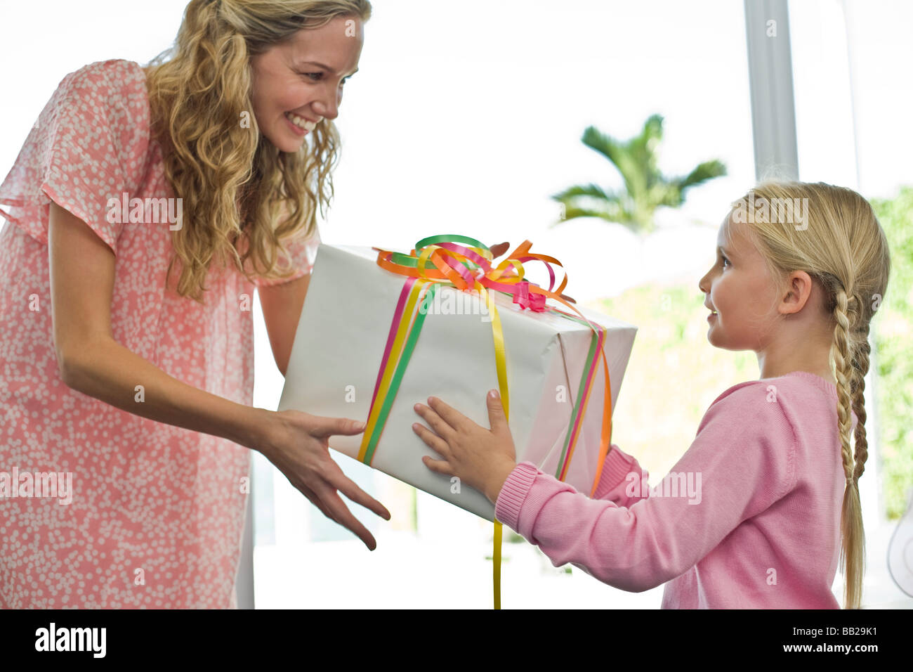 Girl giving present to her mother Stock Photo - Alamy