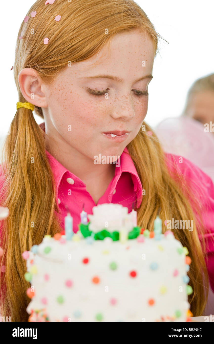 Girl eating birthday cake Stock Photo - Alamy