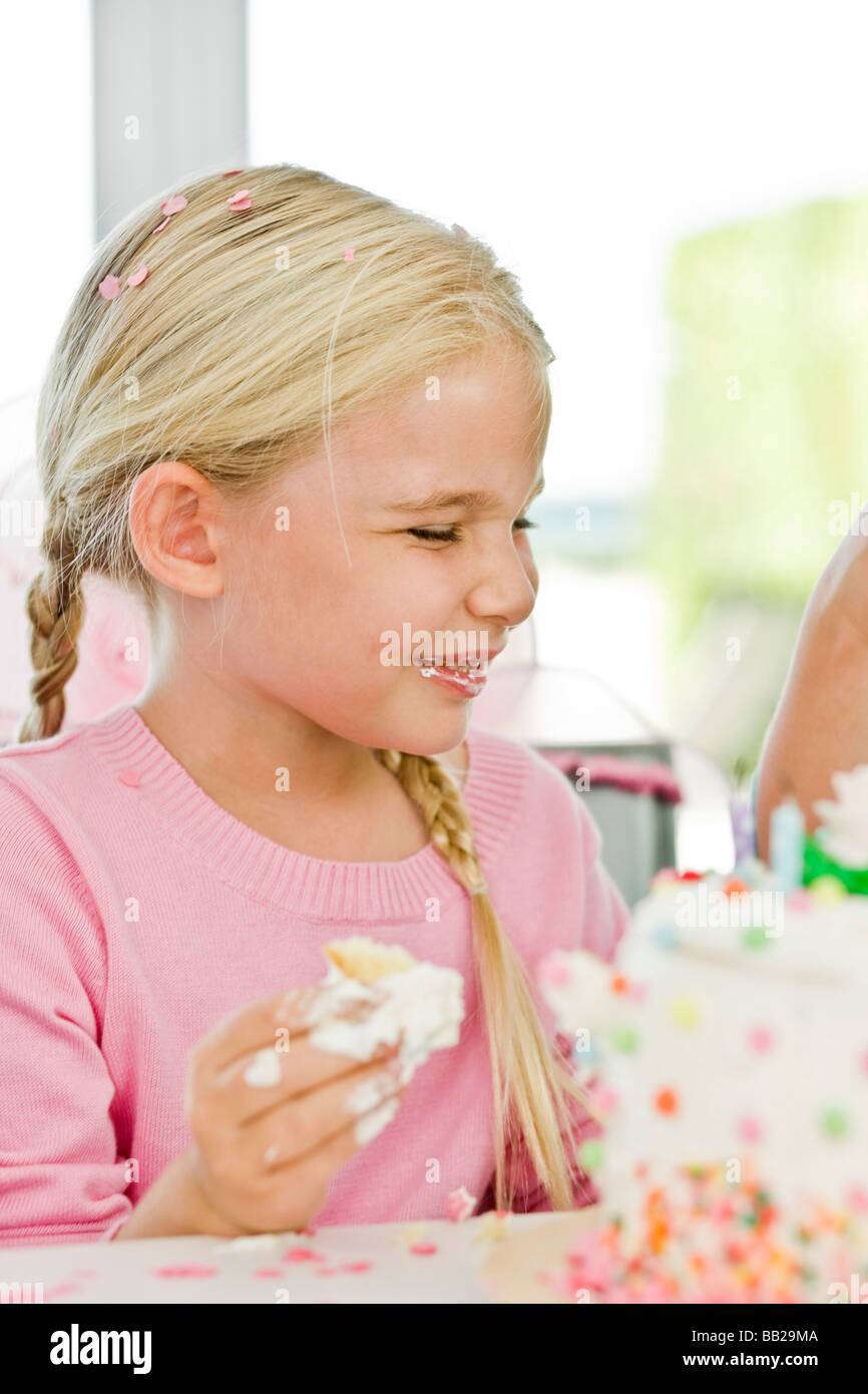 Close-up of a girl eating birthday cake Stock Photo - Alamy