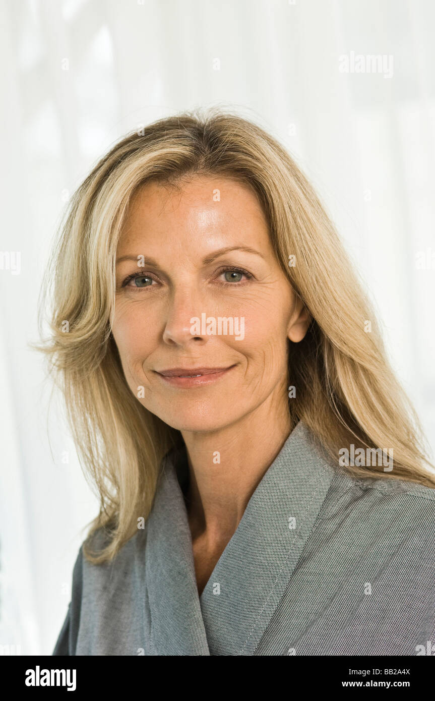 Portrait of a woman smirking Stock Photo - Alamy