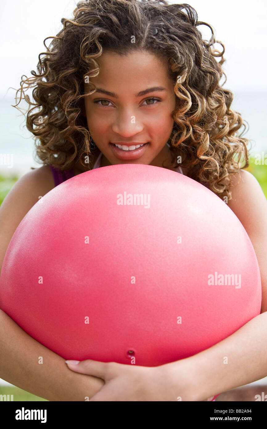 Portrait of a girl hugging a ball and smiling Stock Photo - Alamy