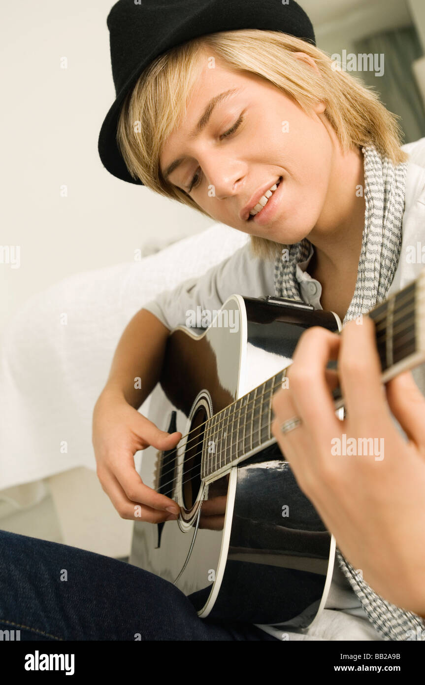 Teenage boy playing a guitar Stock Photo - Alamy