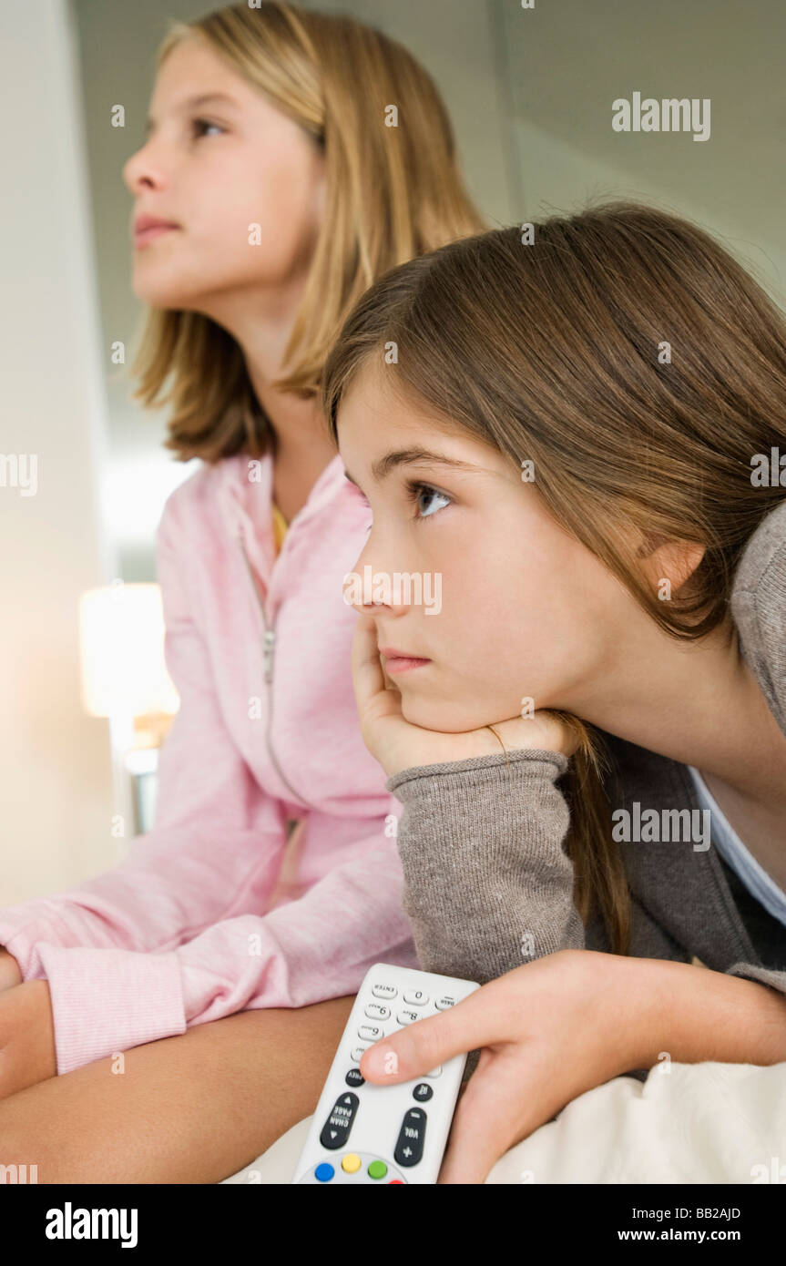 Two girls watching television Stock Photo - Alamy