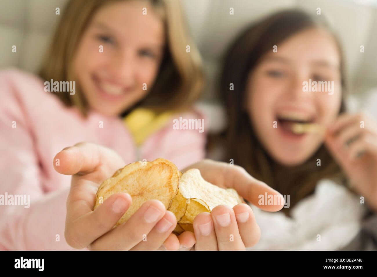 Two girls eating chips hi-res stock photography and images - Alamy