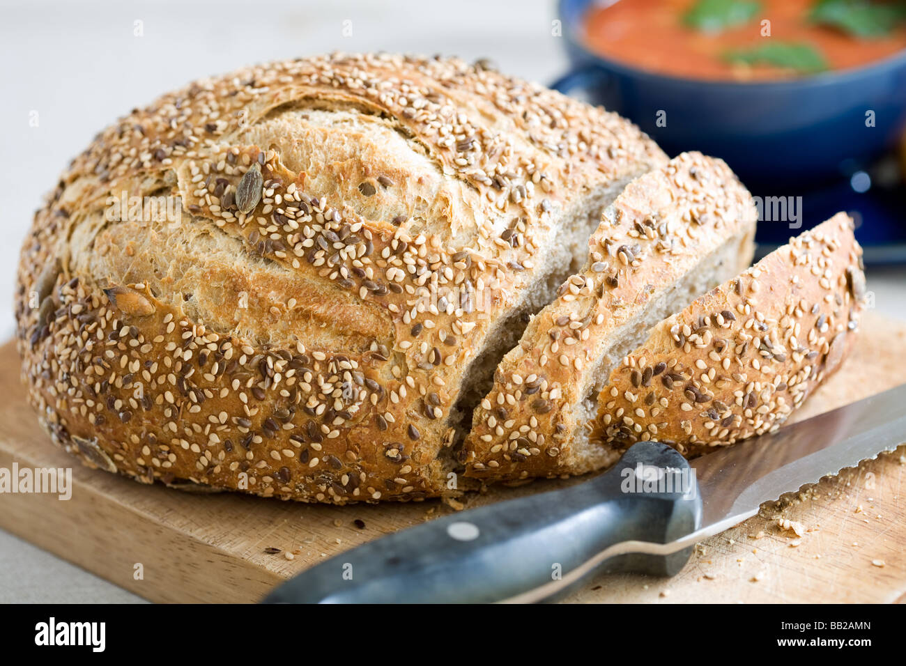 Freshly baked bread cut into slices with a knife Stock Photo - Alamy