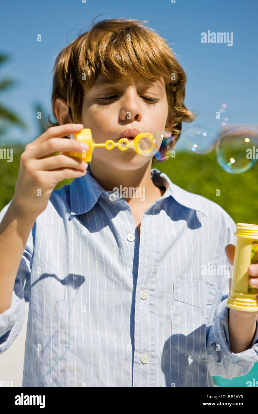 Boy blowing bubbles with a bubble wand Stock Photo - Alamy