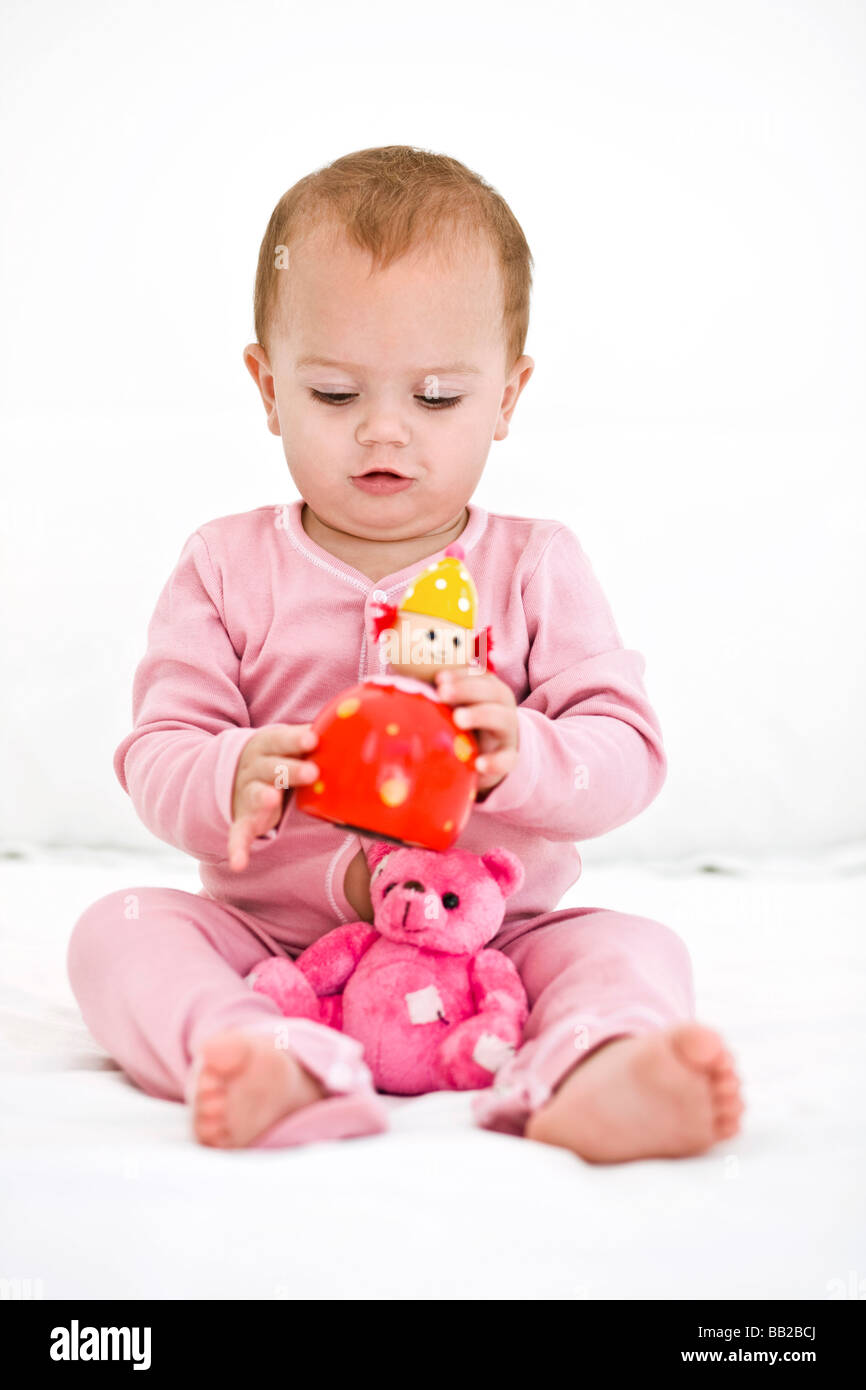 Baby girl playing with toys Stock Photo - Alamy