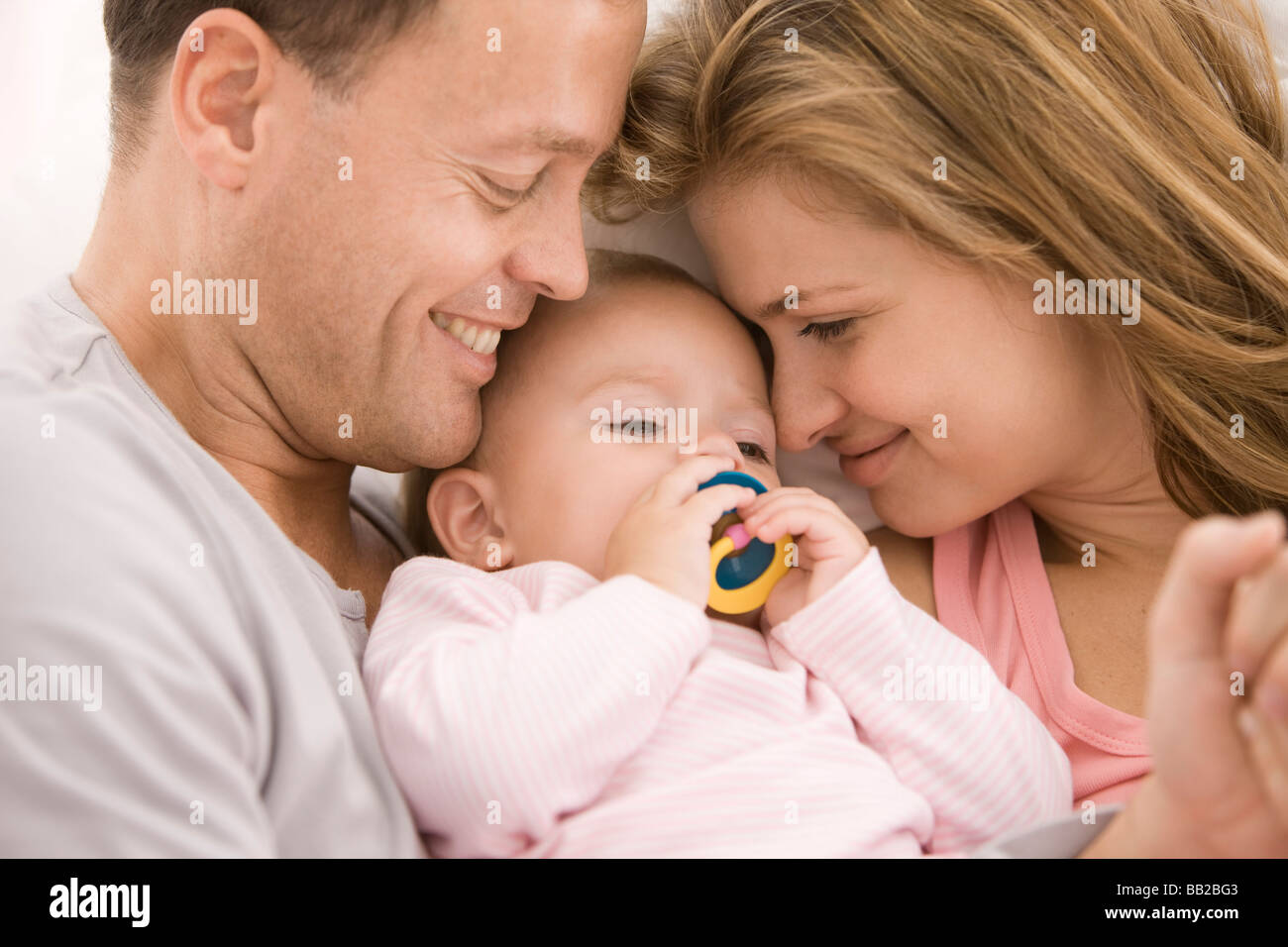 Parents pampering their daughter Stock Photo - Alamy