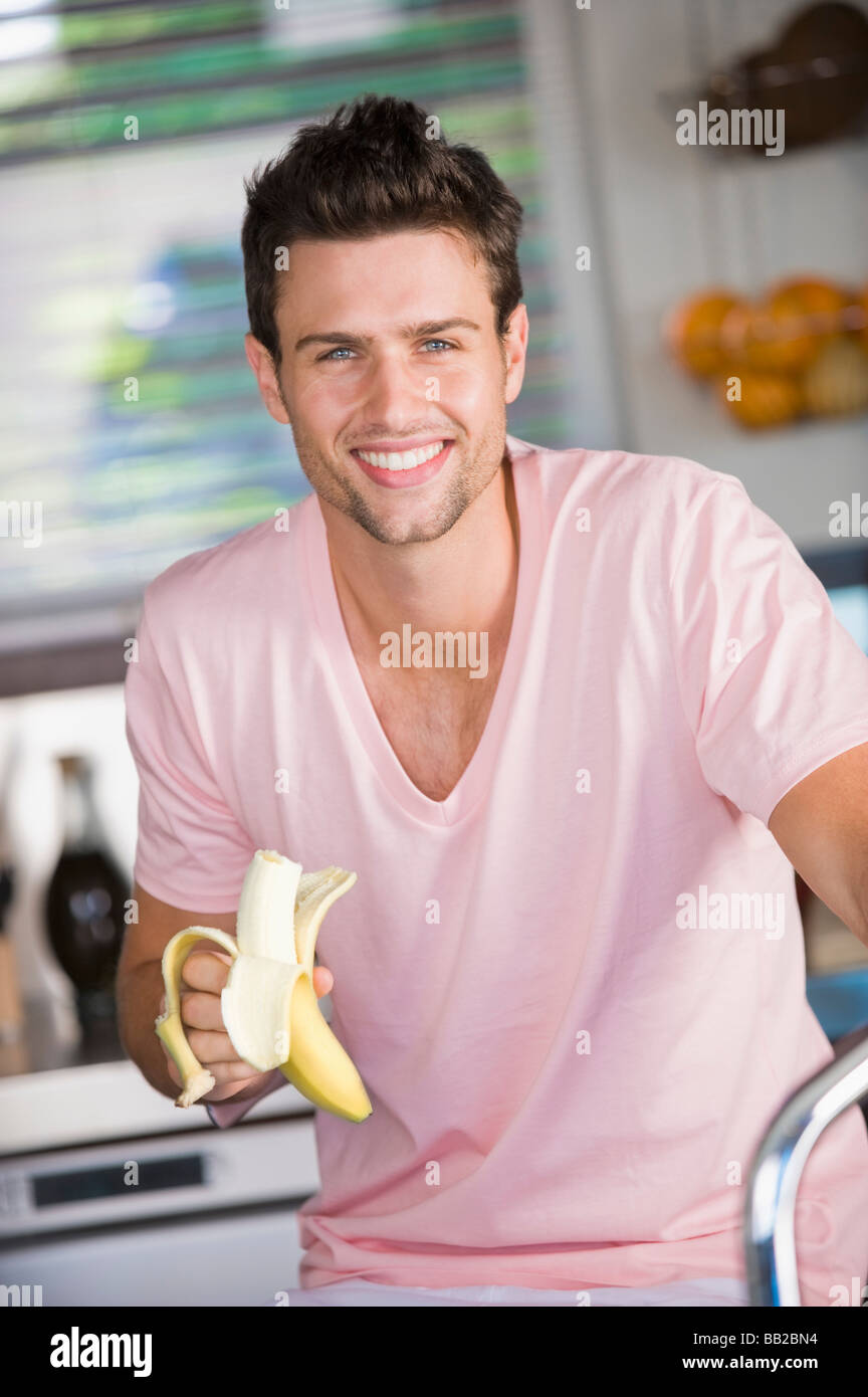 Portrait of a man eating a banana Stock Photo - Alamy