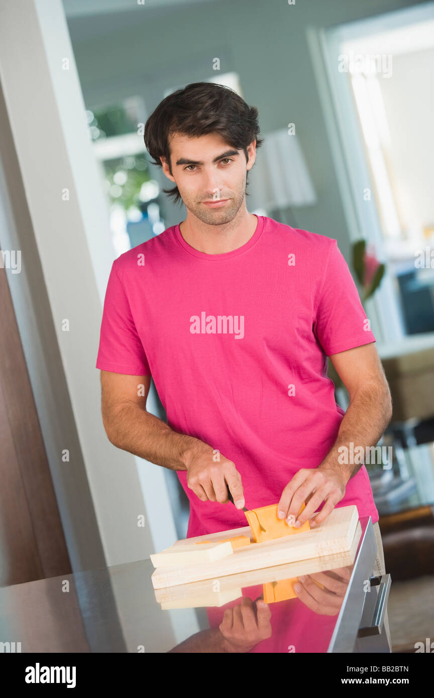 Man cutting cheese slices Stock Photo - Alamy