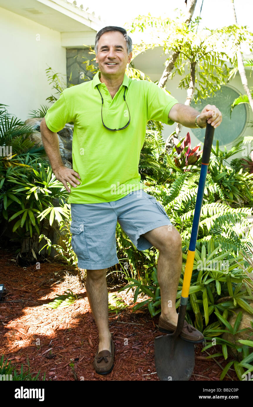 Portrait of a man holding a shovel Stock Photo - Alamy
