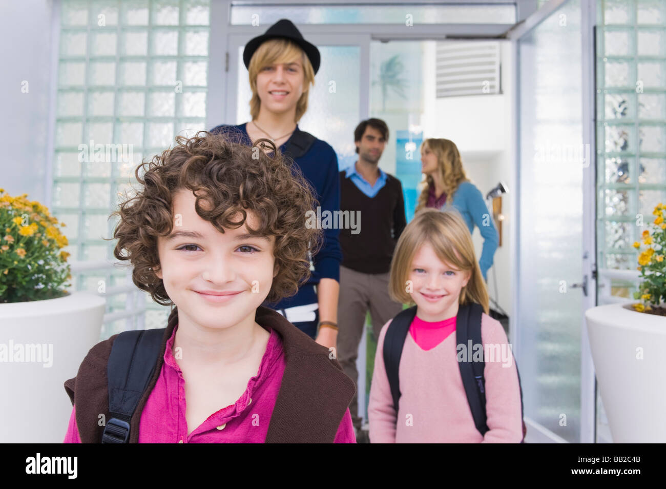 Children with a nanny leaving for school Stock Photo - Alamy