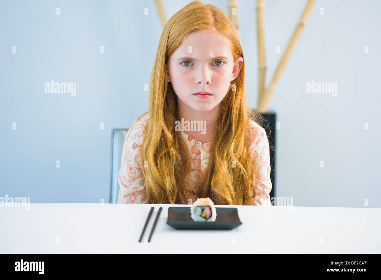 Portrait of a girl at a dining table Stock Photo - Alamy
