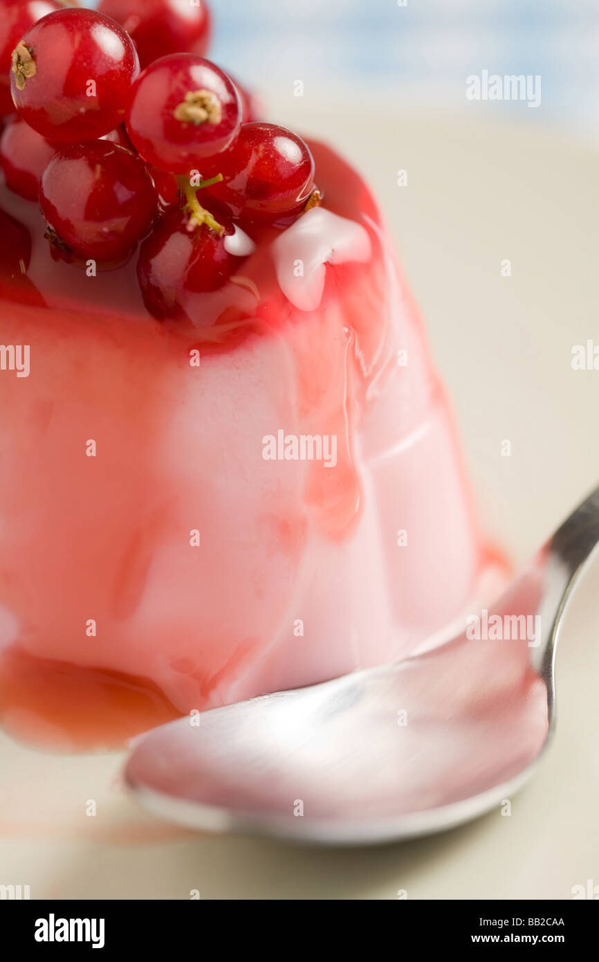 Delicious pink panna cotta pudding topped with red berries Stock Photo ...