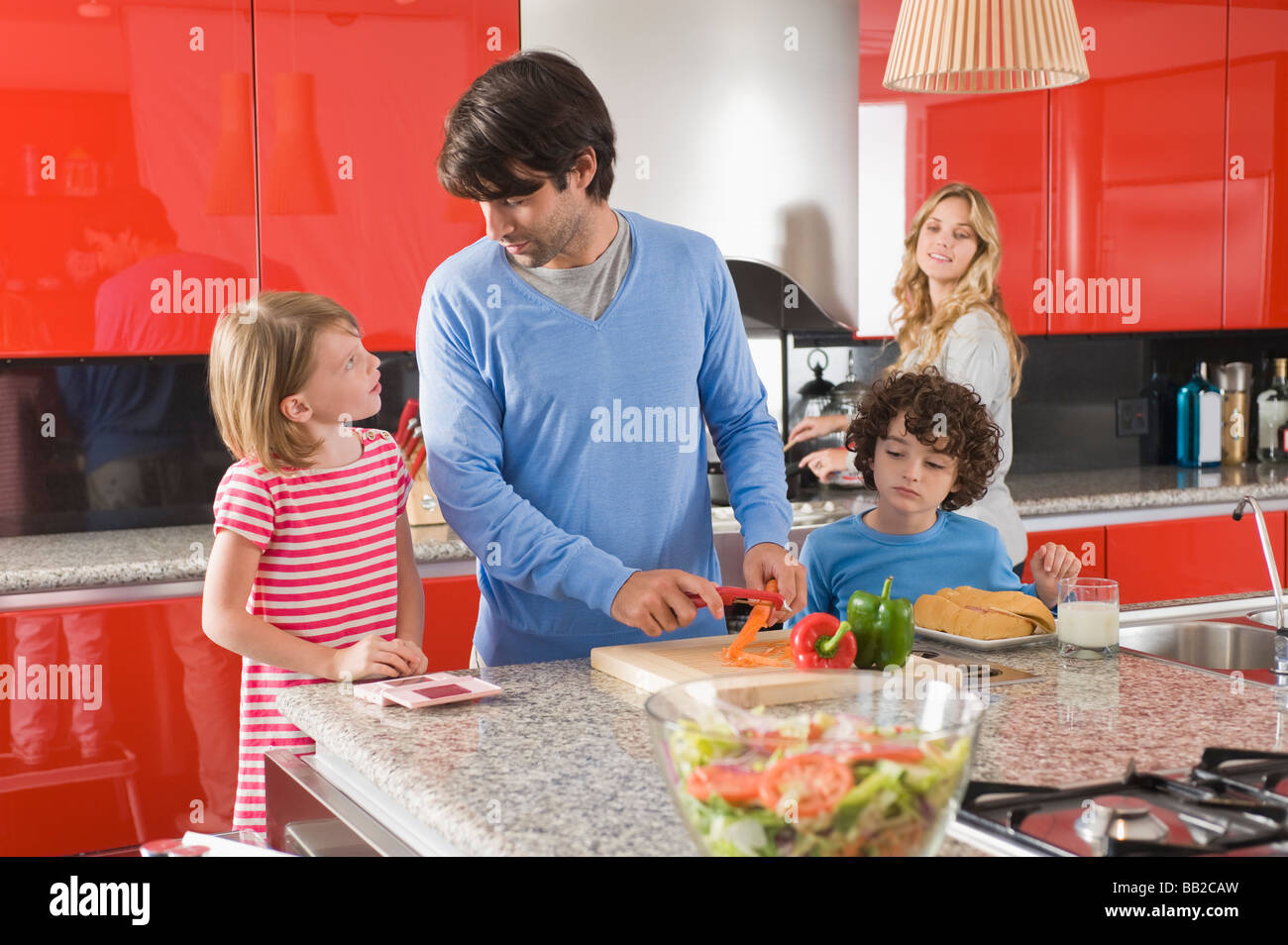 Family in the kitchen Stock Photo - Alamy