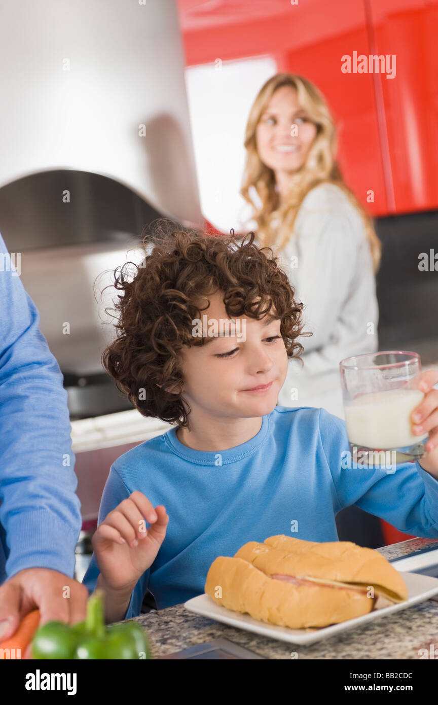 Boy having breakfast in the kitchen Stock Photo - Alamy