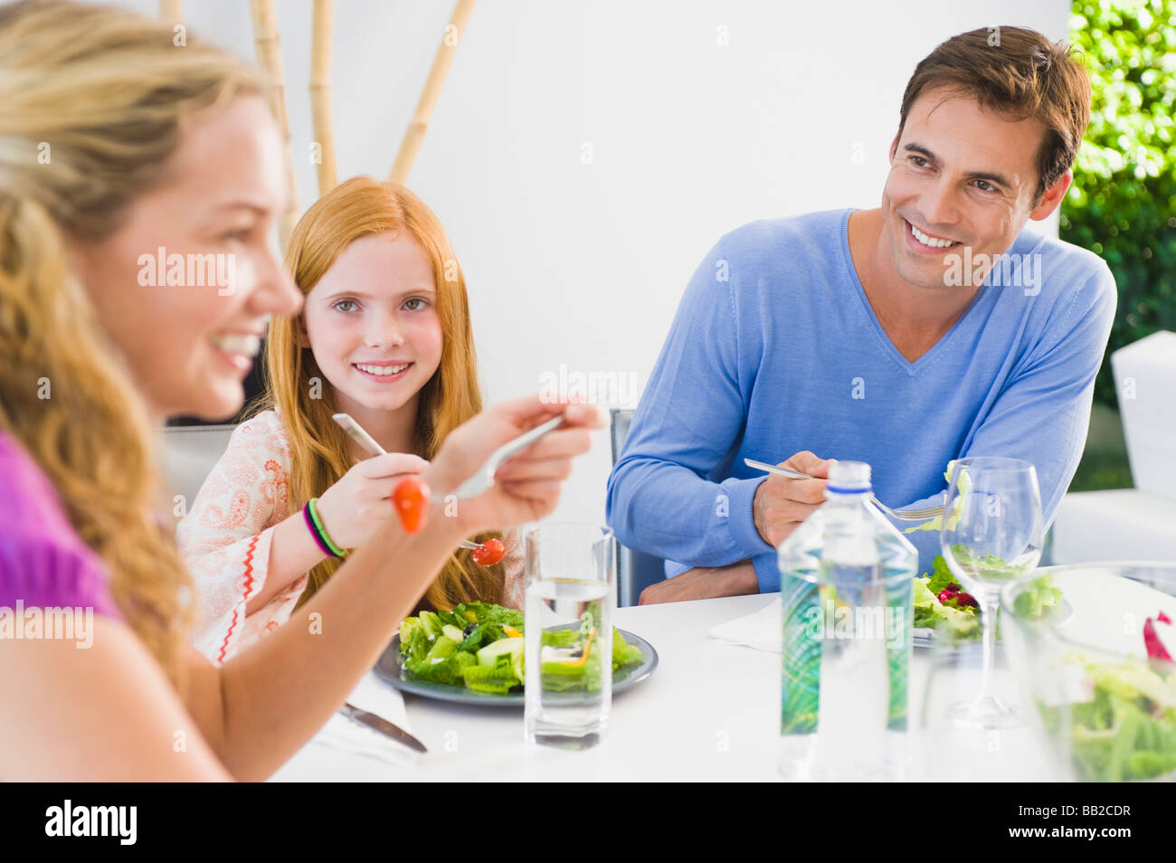 Family having lunch and smiling Stock Photo - Alamy
