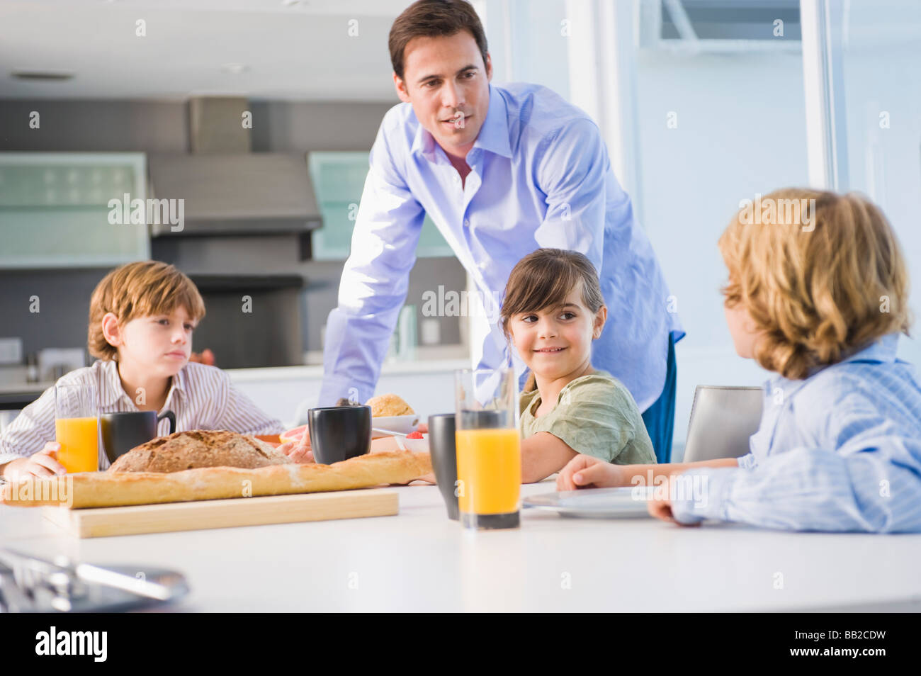 Family at the breakfast table Stock Photo - Alamy