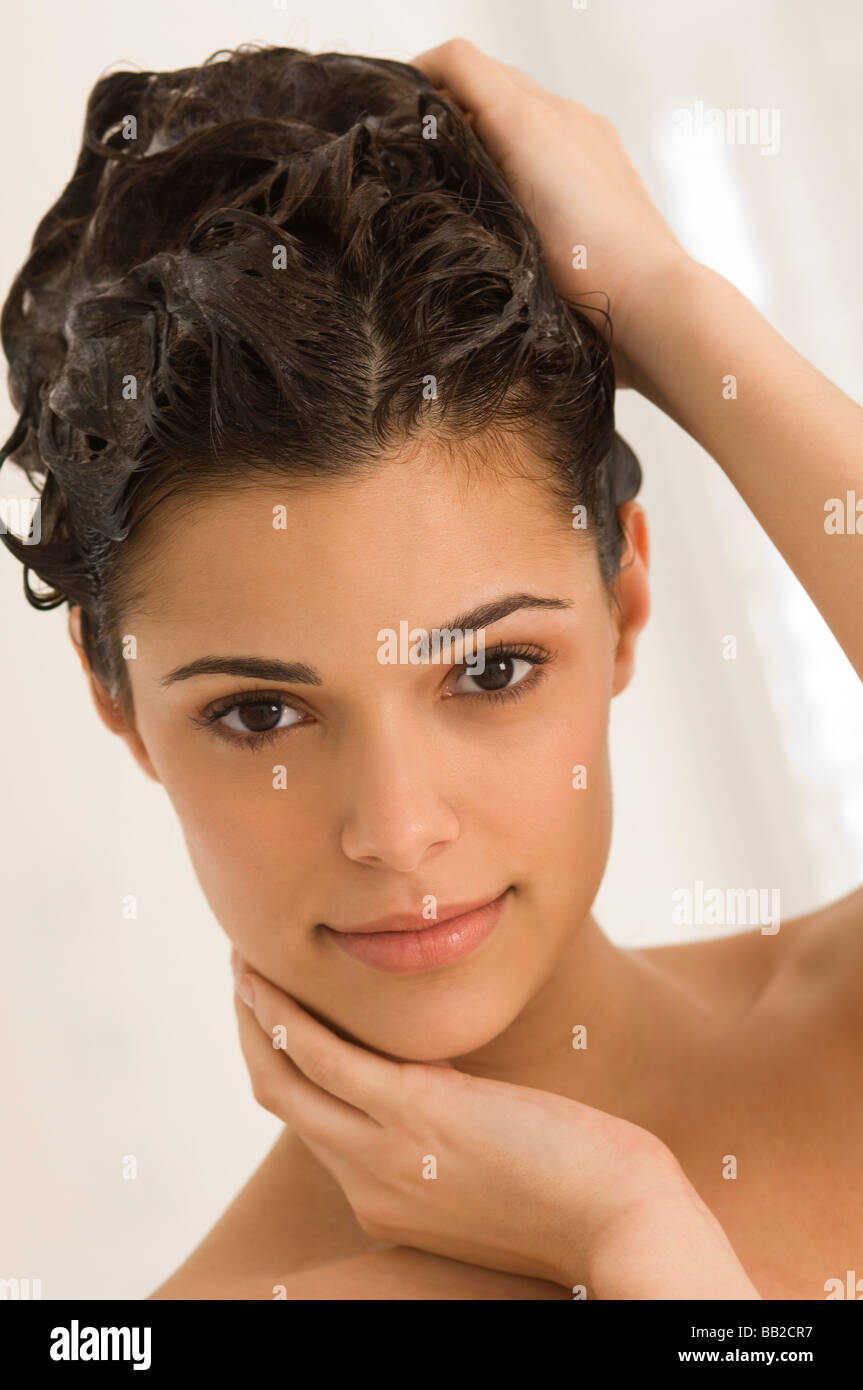 Portrait of a woman shampooing her hair Stock Photo - Alamy