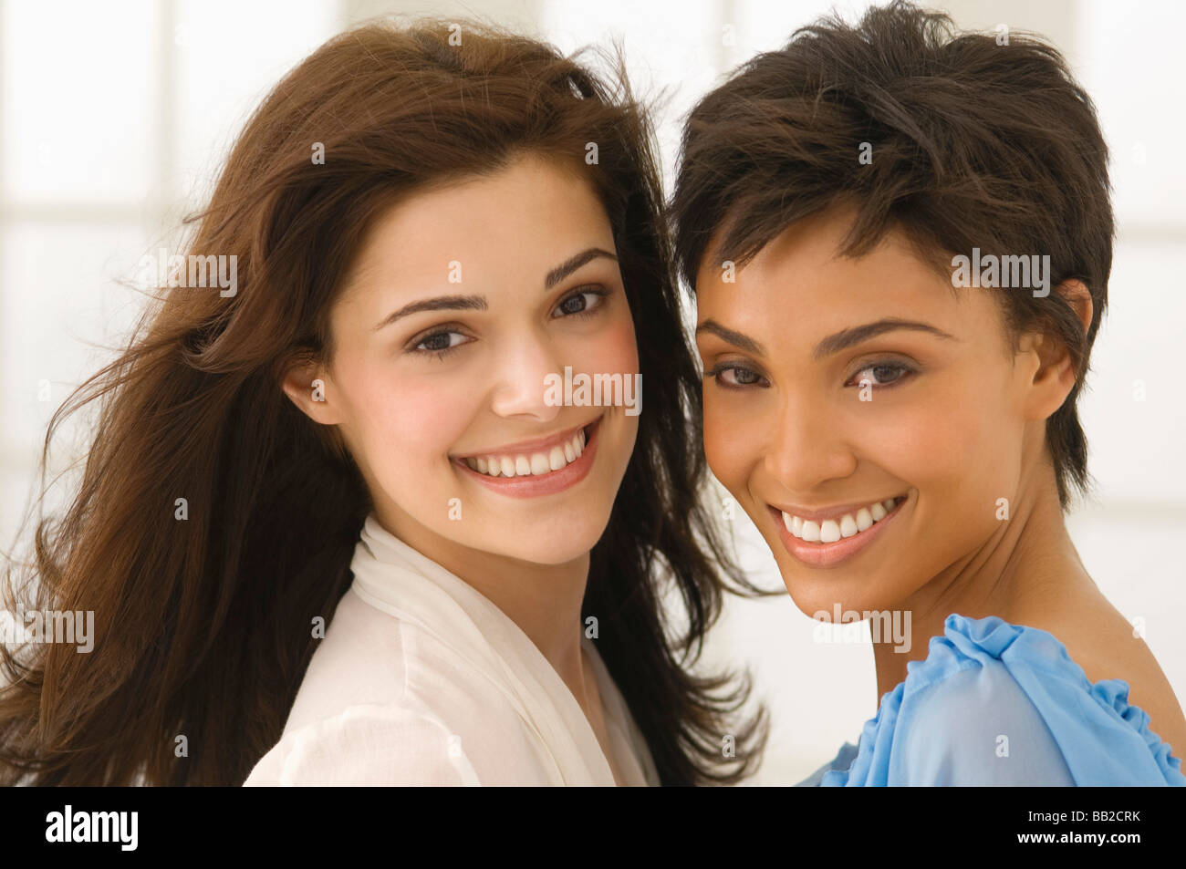 Portrait of two female friends smiling Stock Photo - Alamy