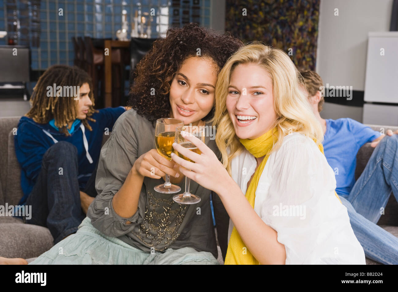 Two women toasting with wine glasses Stock Photo - Alamy