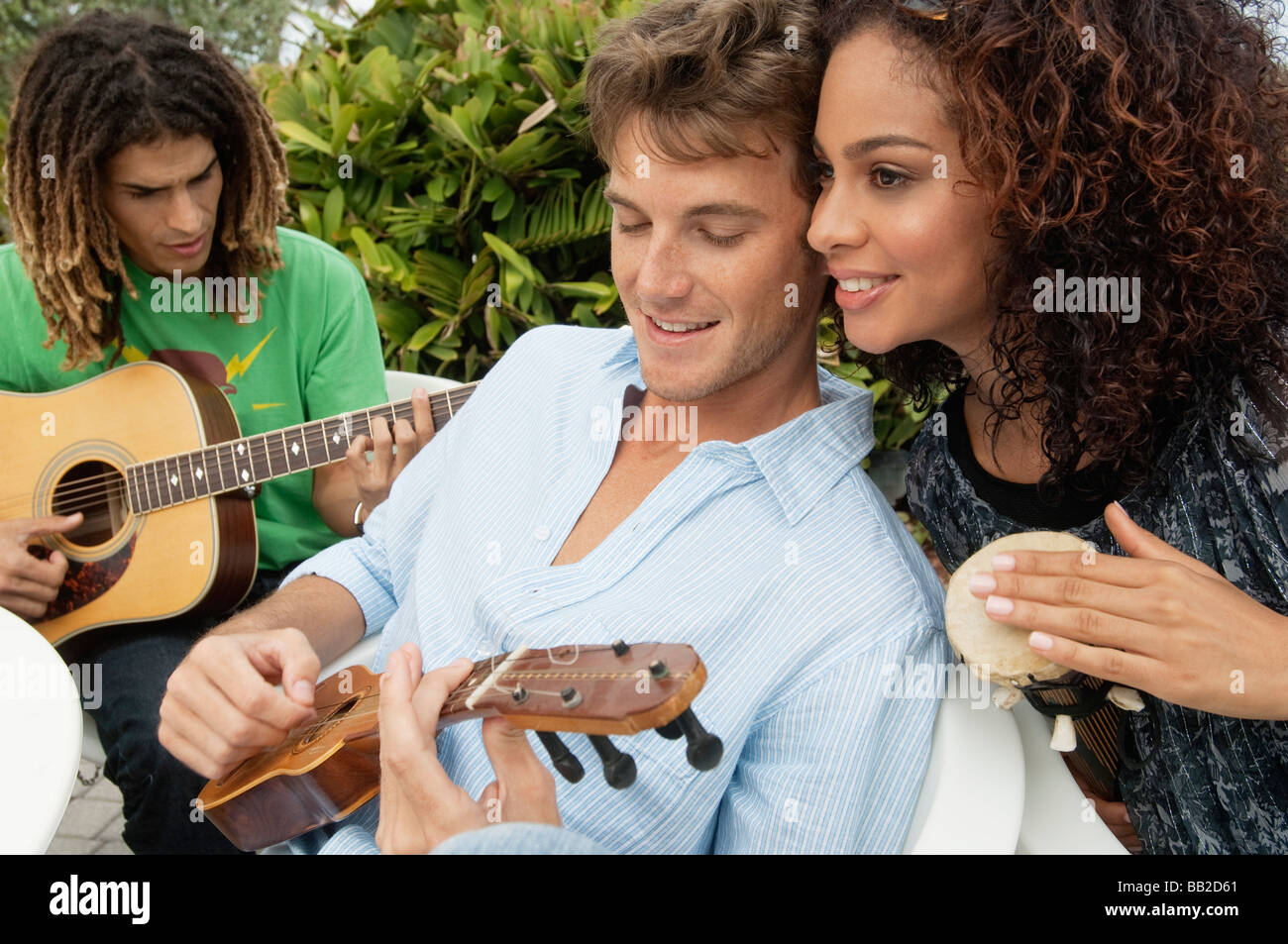 Friends playing musical instruments Stock Photo - Alamy