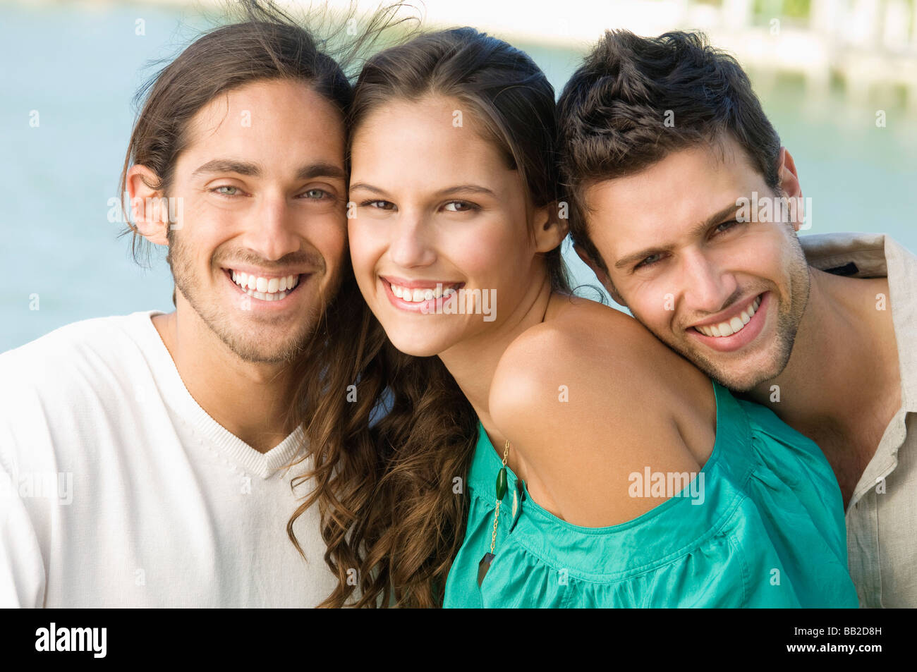 Three friends smiling Stock Photo - Alamy