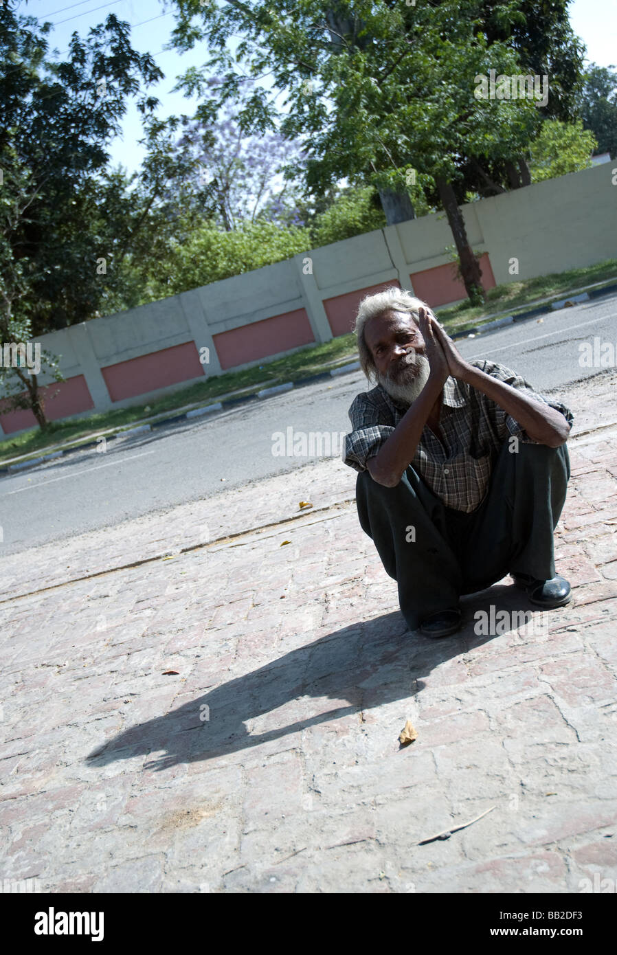 crouching Indian man Stock Photo - Alamy
