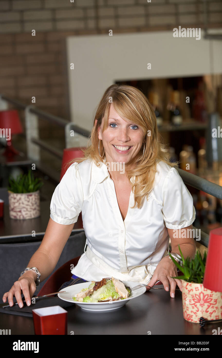 Attractive blond business woman having a healthy lunch Stock Photo - Alamy