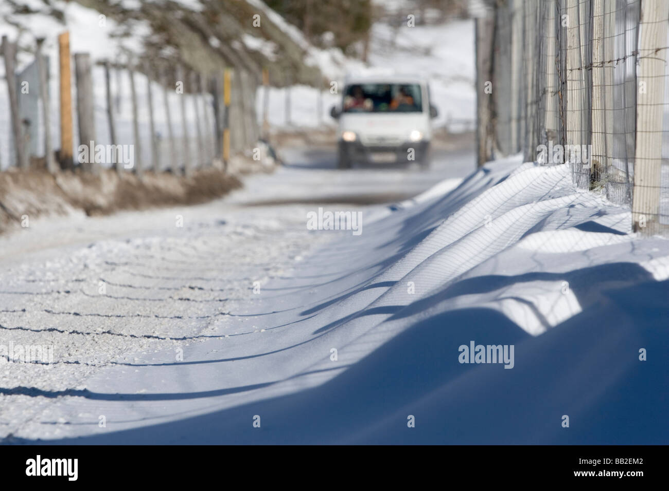 van passing through drifting snow across mountain road Stock Photo - Alamy