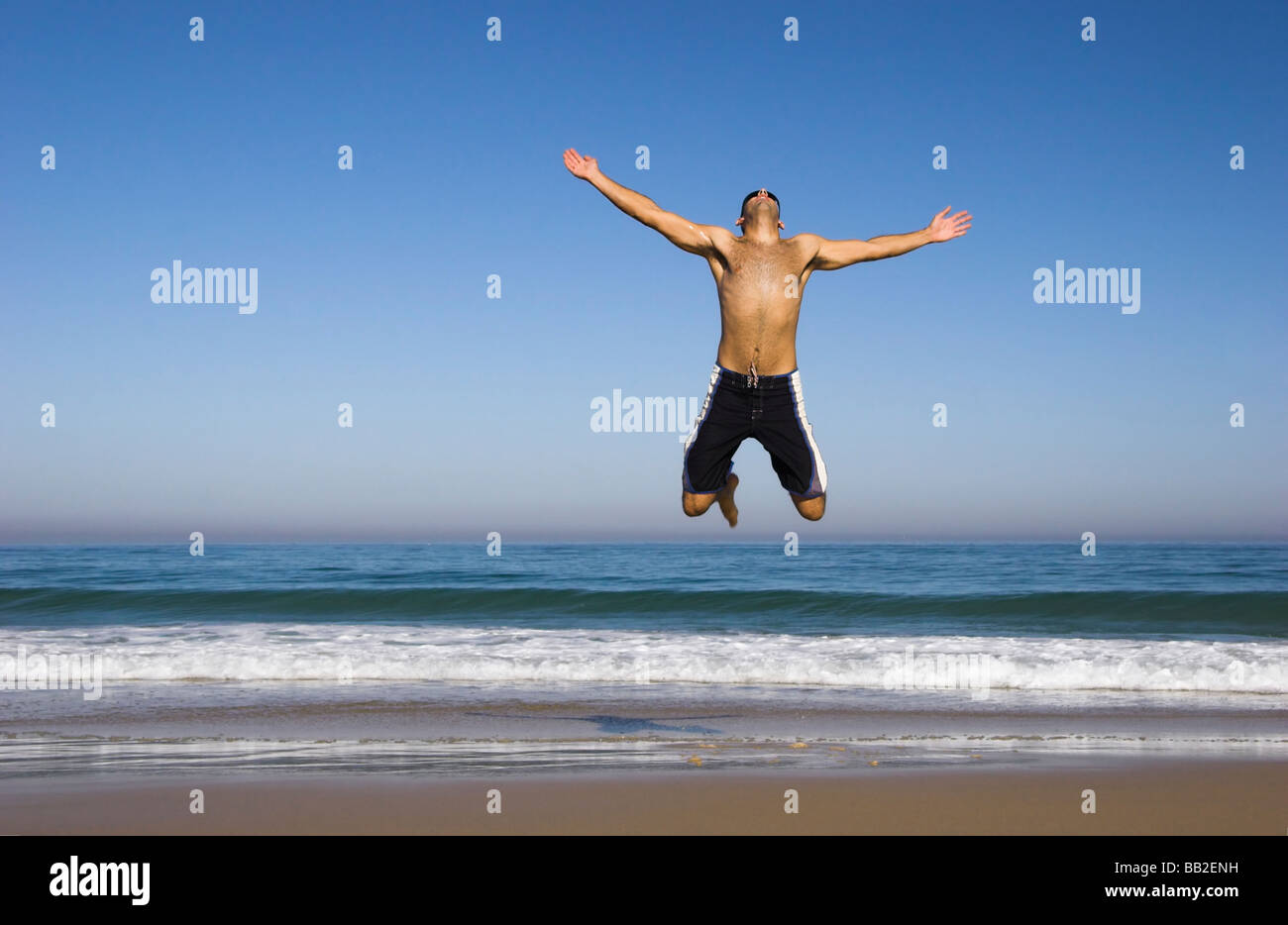 Man running and jumping on the beach Stock Photo - Alamy