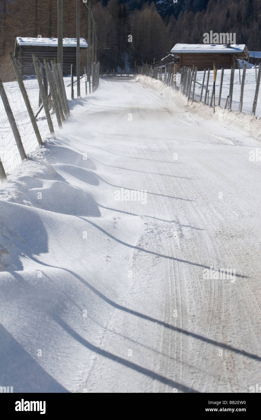 drifting snow across mountain road Stock Photo - Alamy