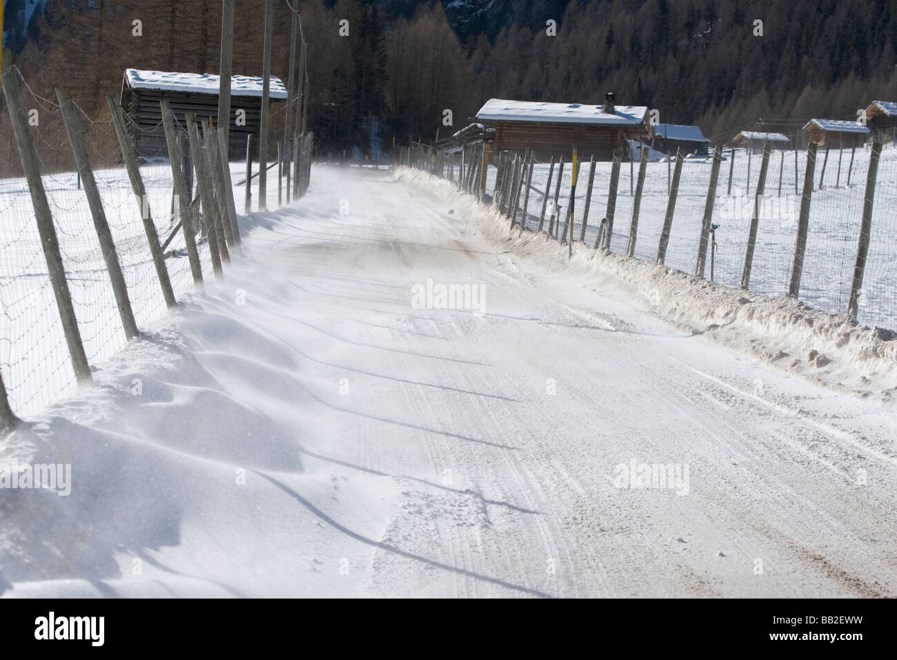 drifting snow across mountain road Stock Photo - Alamy