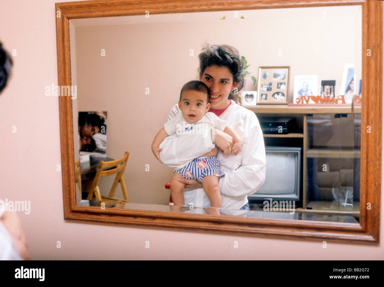 baby reflect see self mirror curious grow learn touch Stock Photo - Alamy