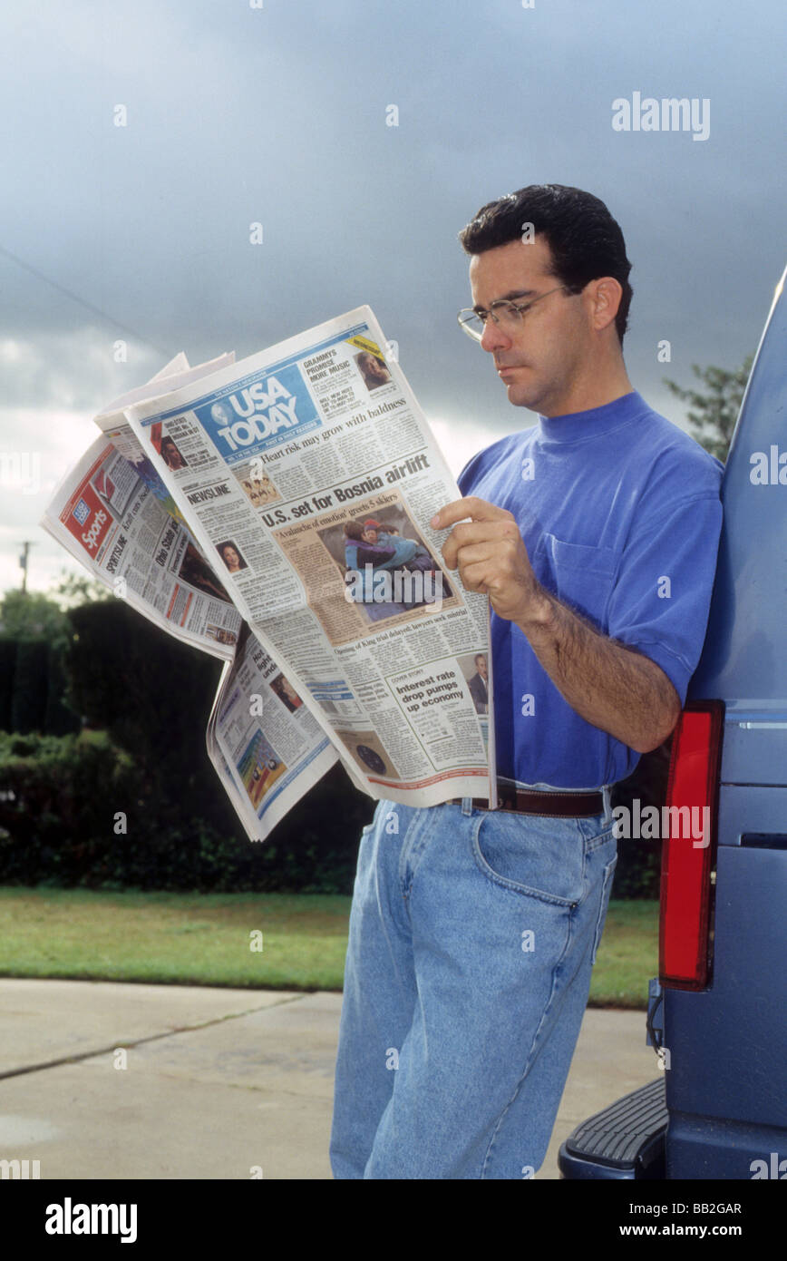 man read news paper serious angry mad intent concentrate learn discover ...