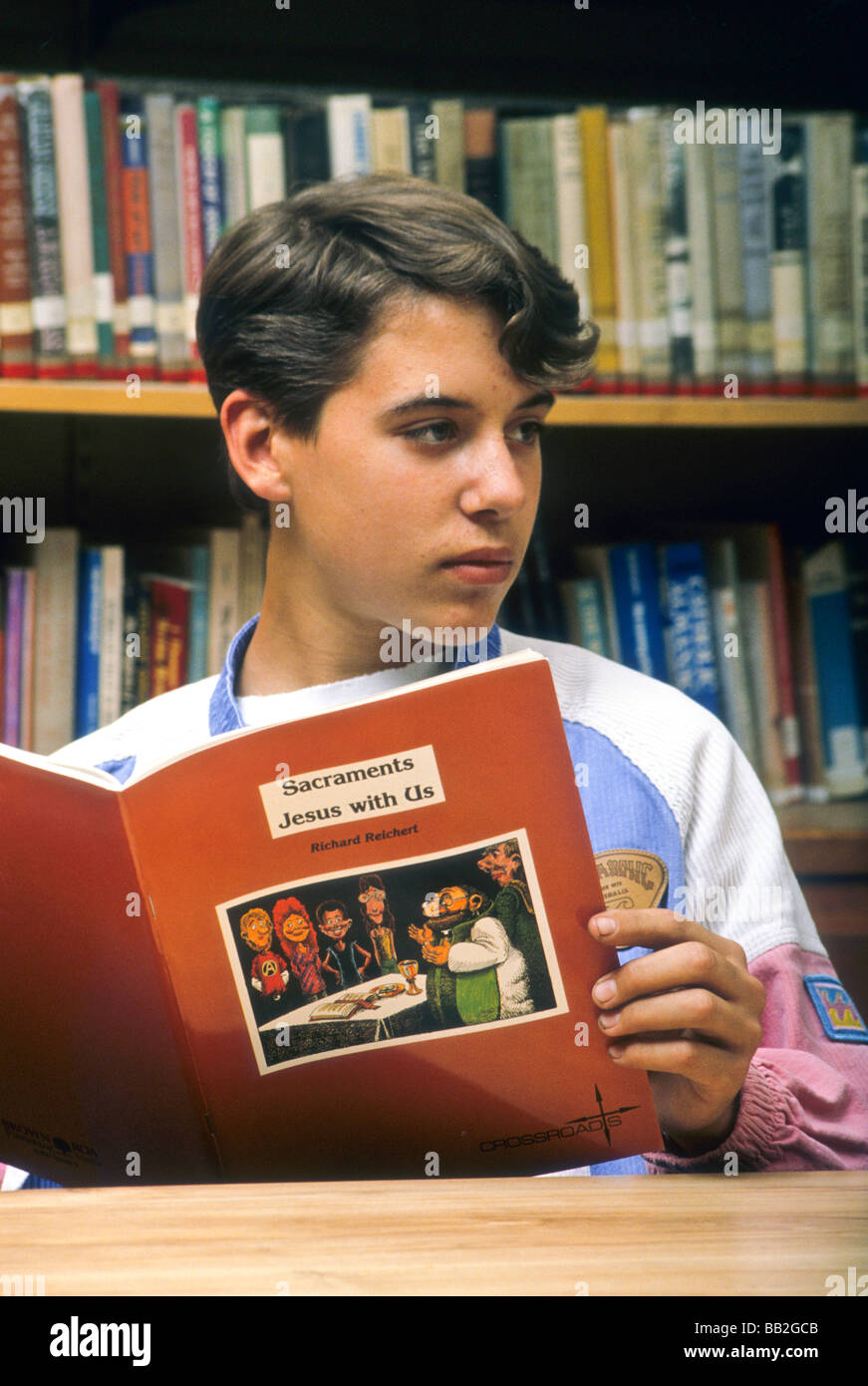 Teen boy read book religion religious serious face study library Stock ...